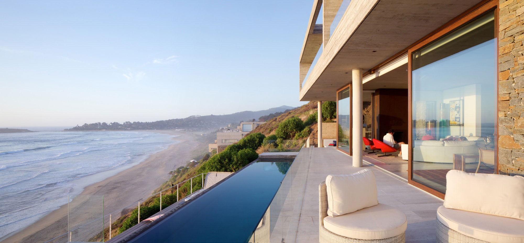 A Colorful and Vibrant Beach House Set on a Steeply Hillside in ...