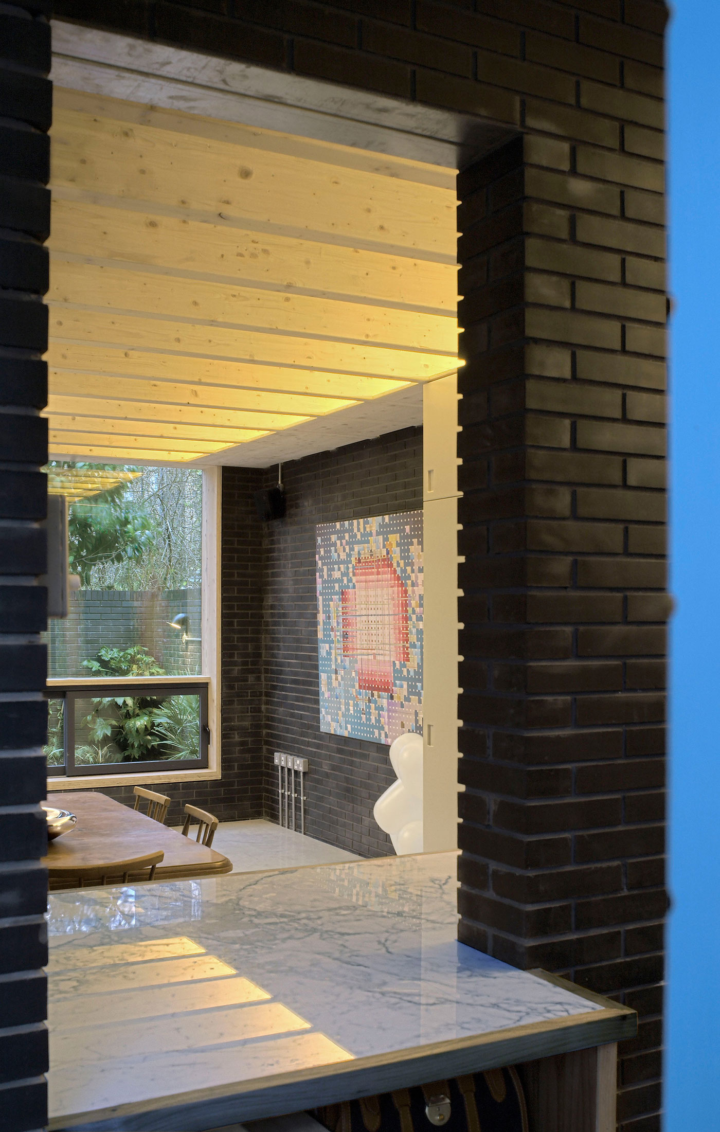 A Fascinating Home with Black Engineering Bricks and Slabs of White ...