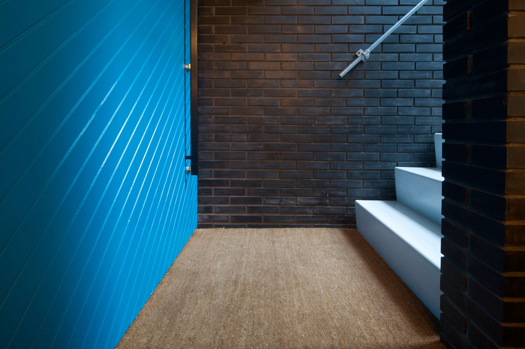 A Fascinating Home with Black Engineering Bricks and Slabs of White ...